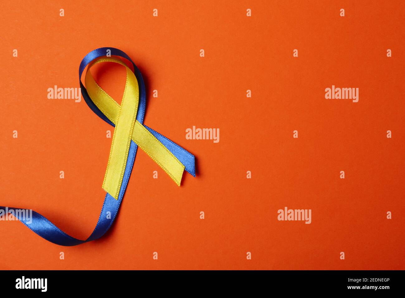 Down Syndrome awareness ribbons on orange background Stock Photo - Alamy