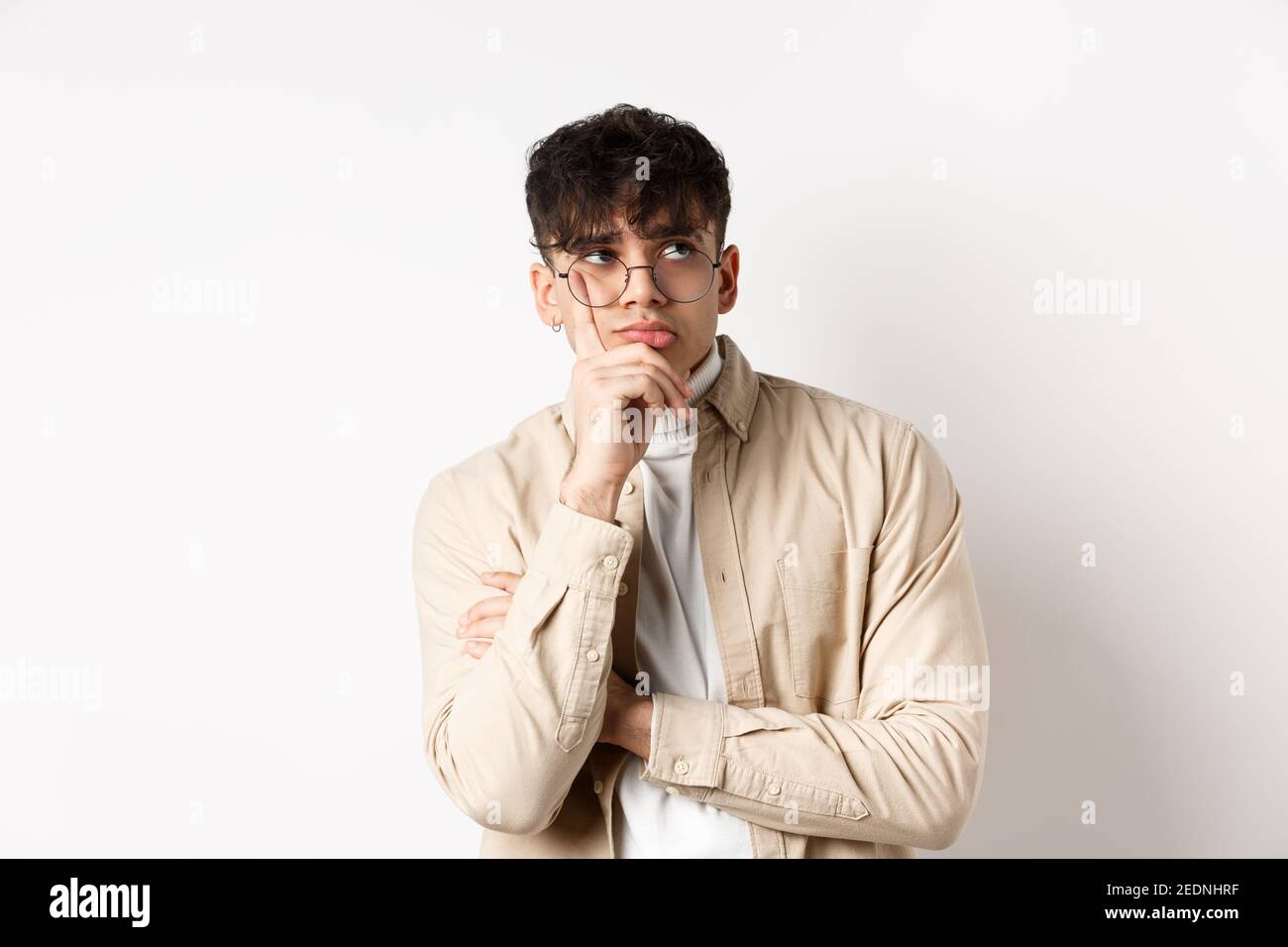 Sad and lonely young man looking at empty space with distressed face ...