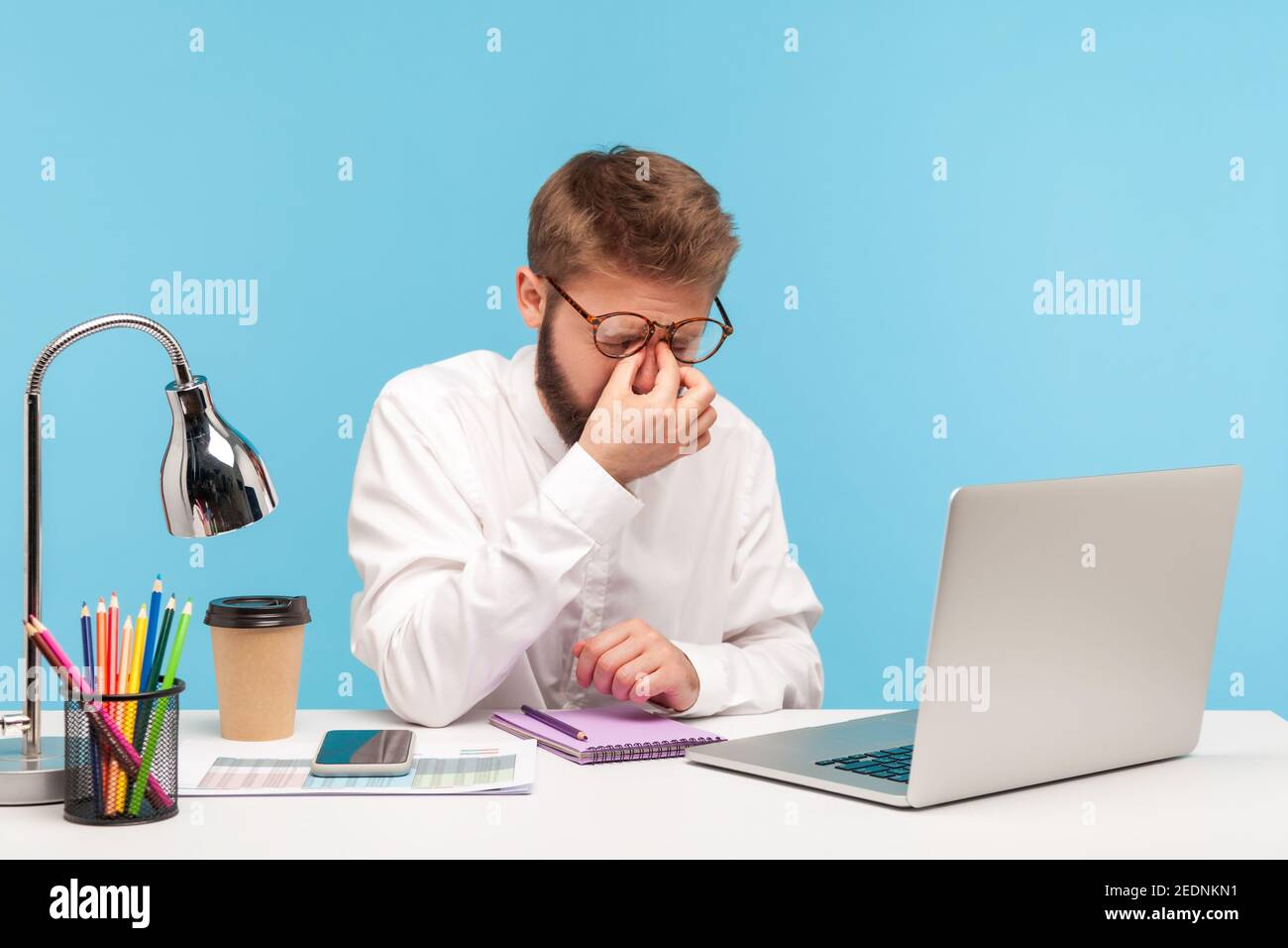 Unhappy frustrated man office worker putting off glasses and rubbing ...