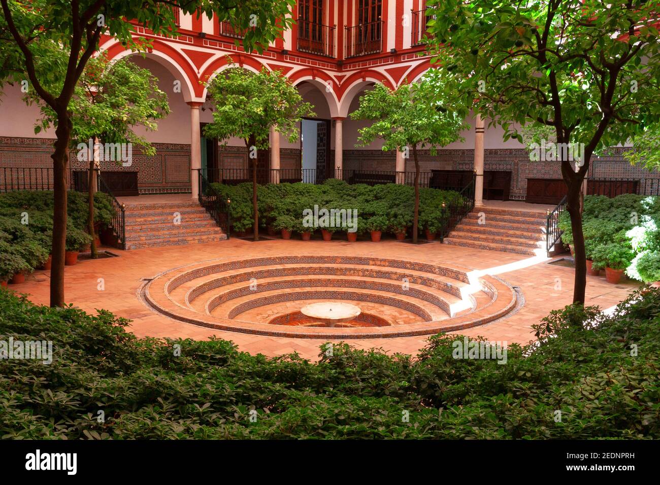 Andalusian courtyard surrounded by arches and columns with circular ...