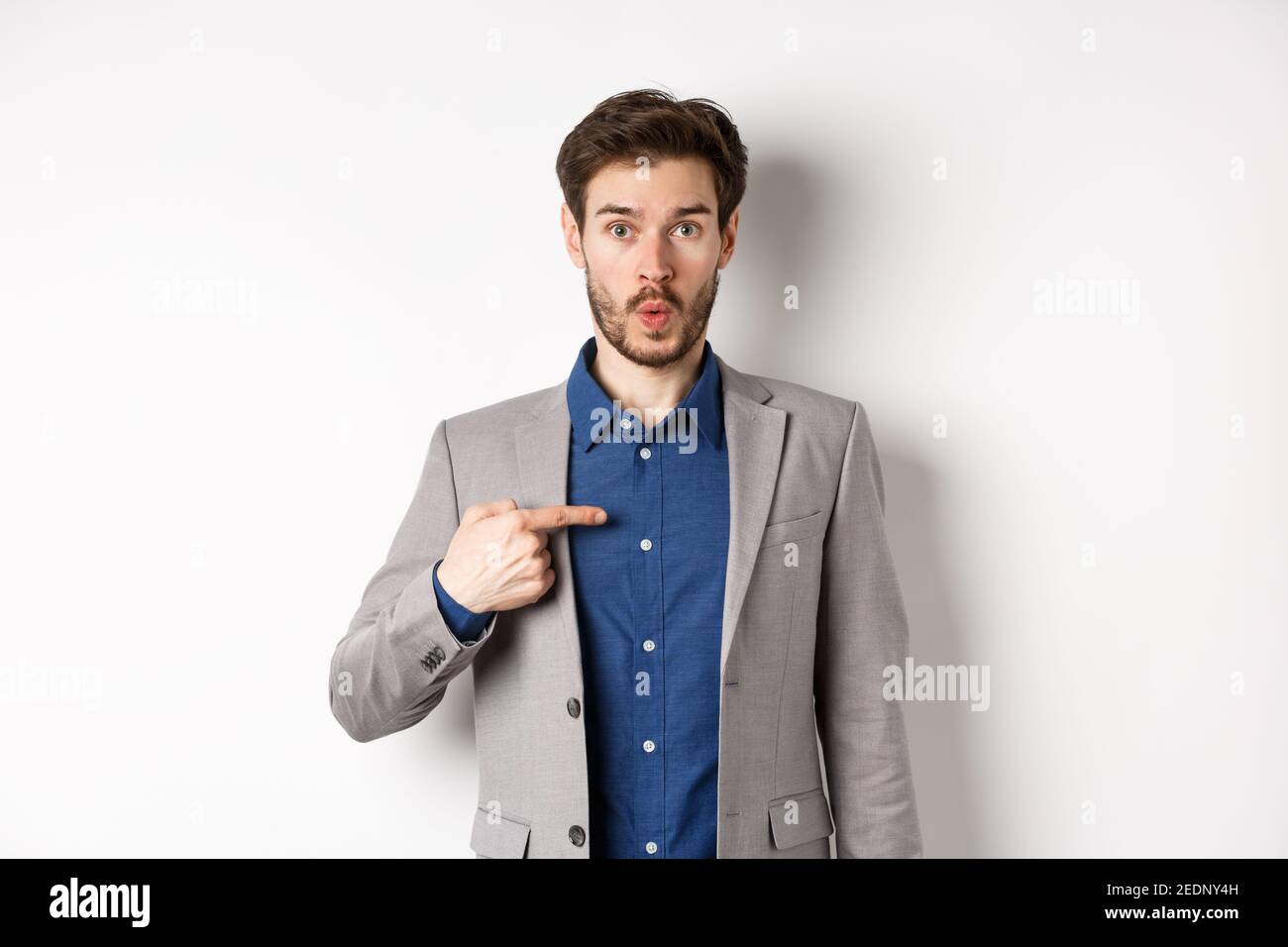 Who me. Surprised man in suit pointing at himself with disbelief ...