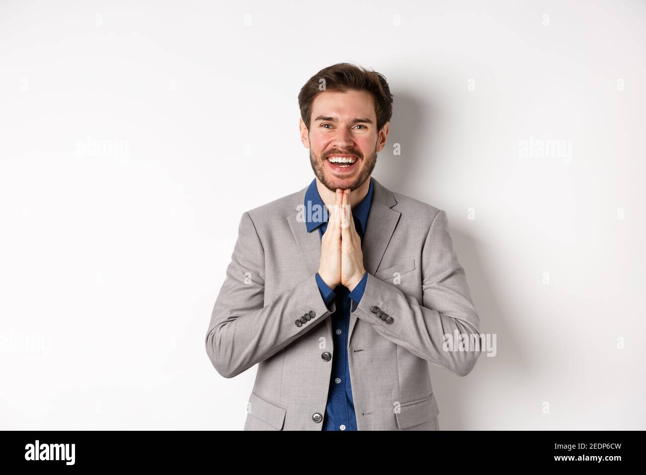 Happy caucasian businessman say thank you, smiling and laughing with ...