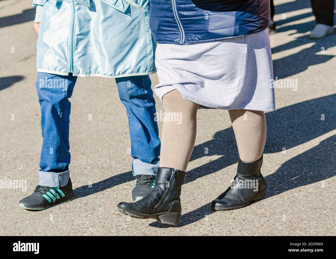 The legs of two women walk along the asphalt path. Autumn Walk. Image ...