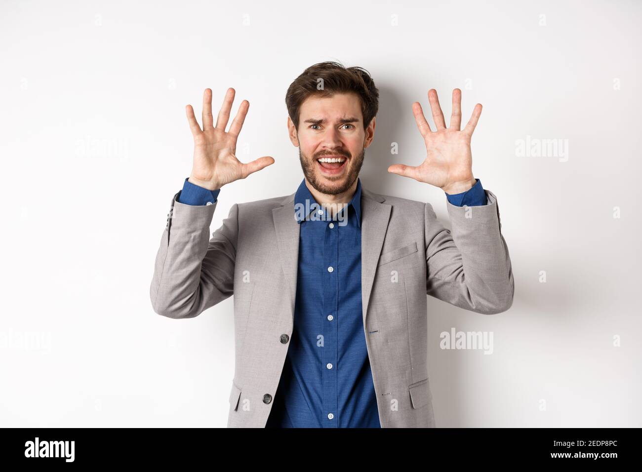 Frustrated man giving up, raising hands up in surrender and screaming ...