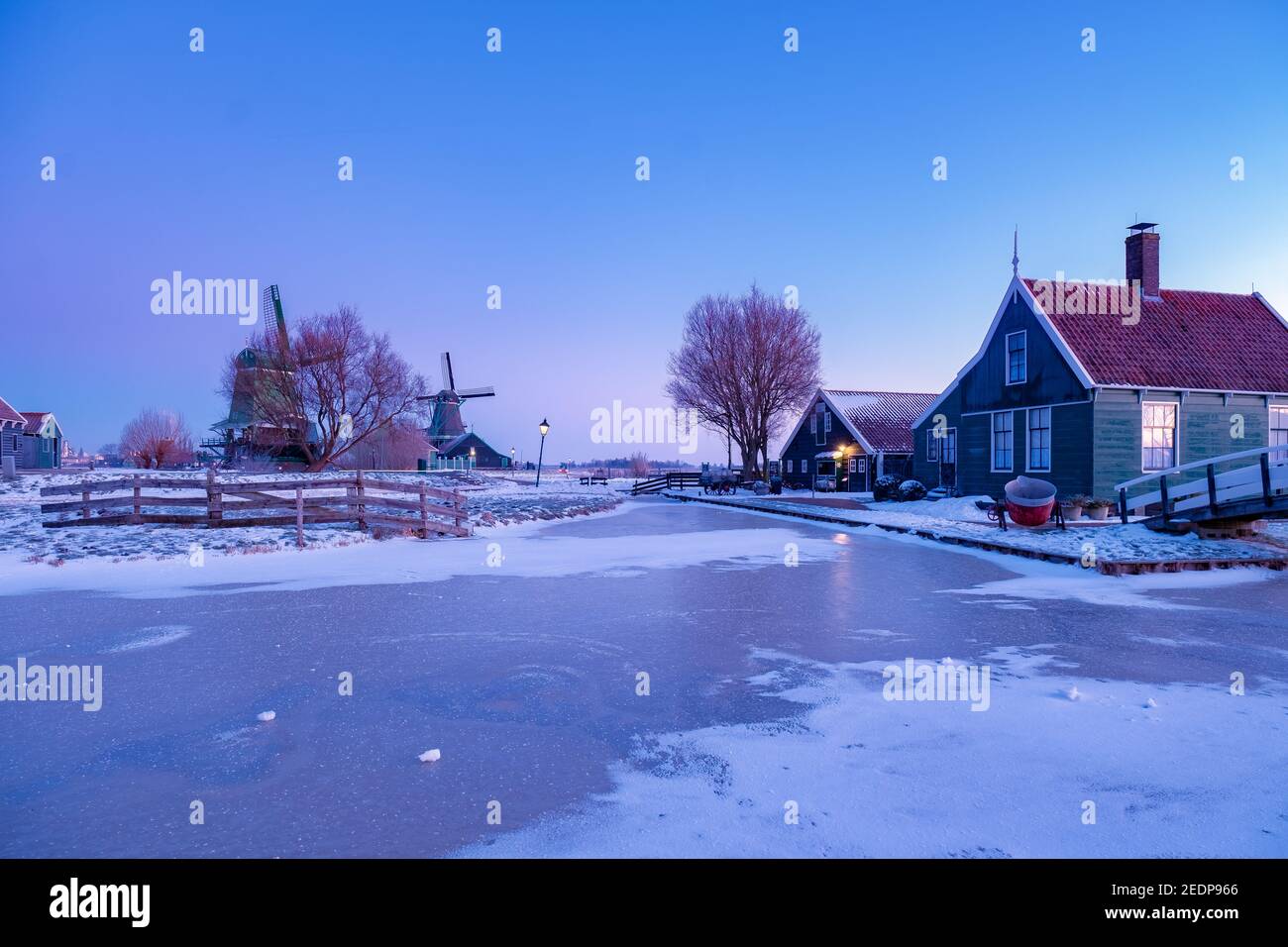 snow covered windmill village in the Zaanse Schans Netherlands ...
