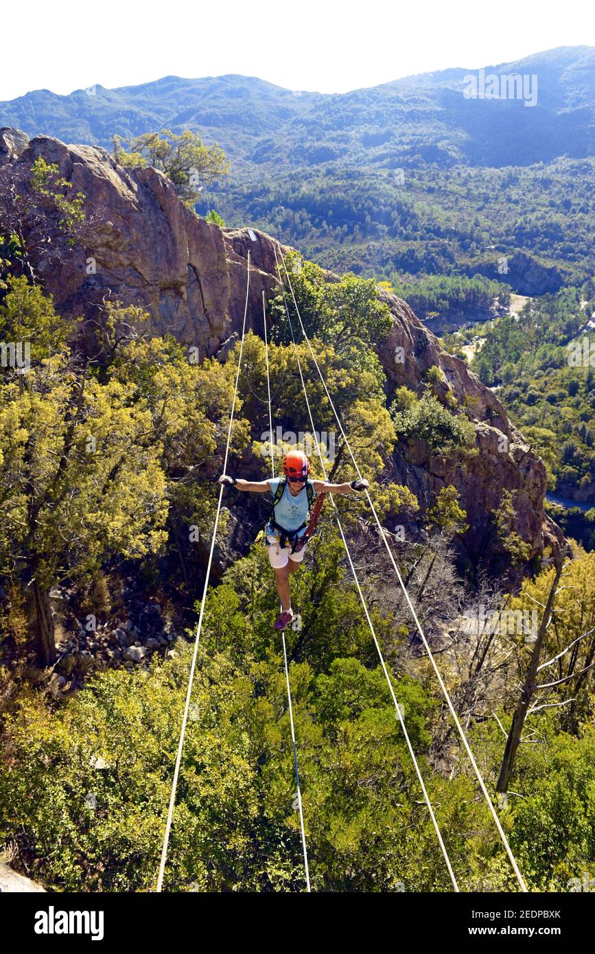 climber crossing a canyon on a wire rope, via ferrata A Buccarona ...
