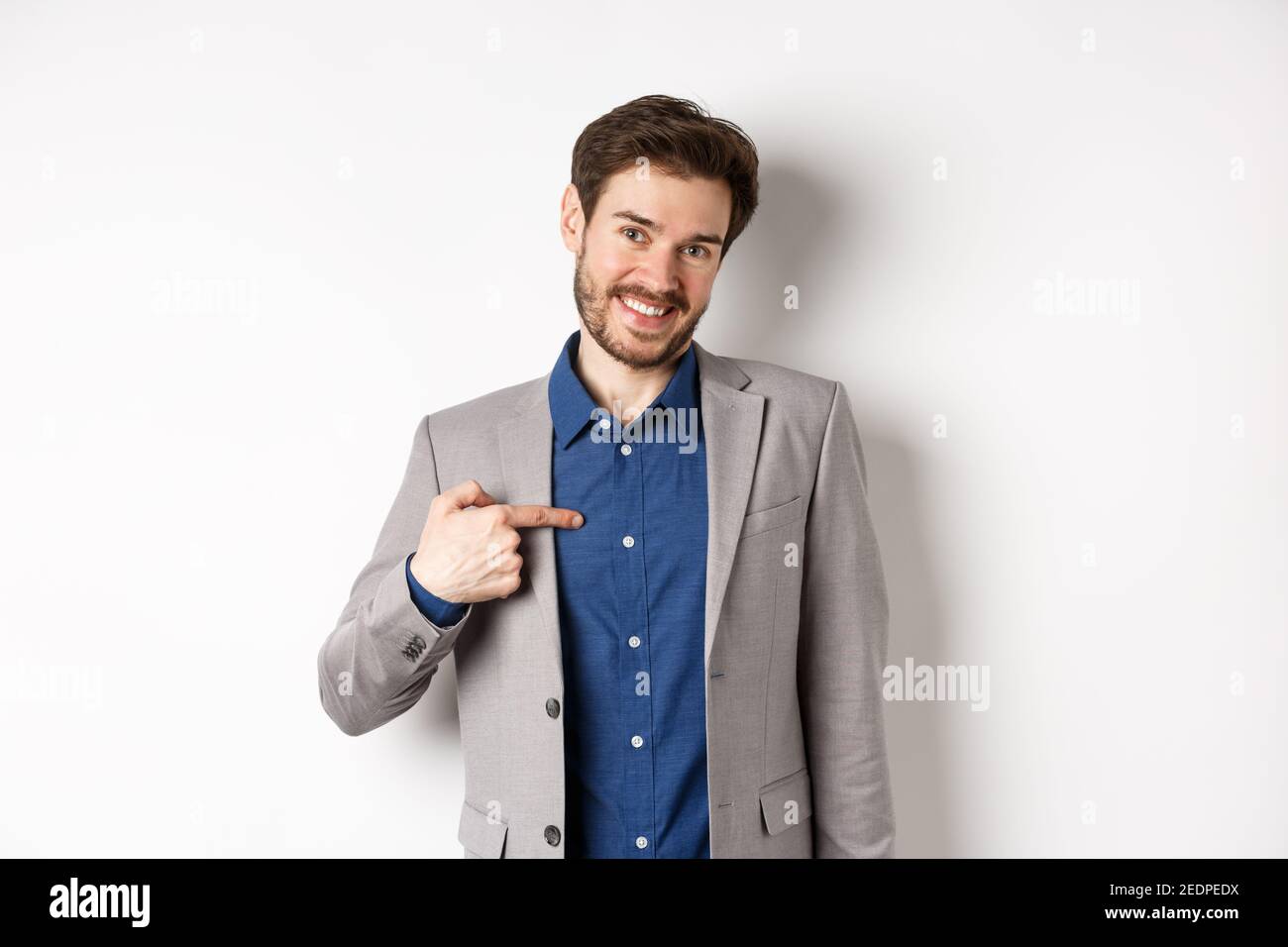 Modest smiling man in suit pointing at himself with cute face, self ...