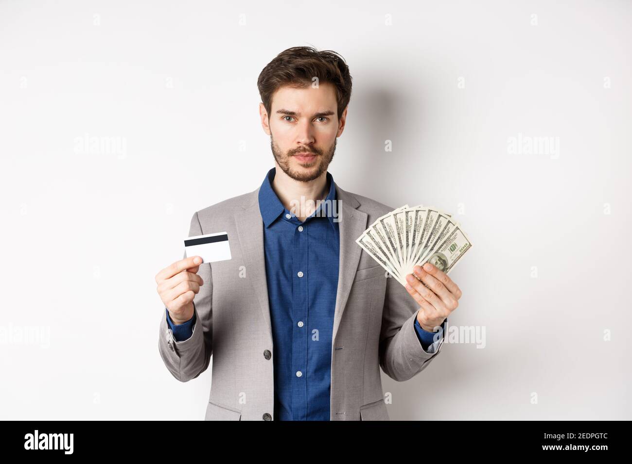 Successful businessman making money, standing in suit with dollar bills ...