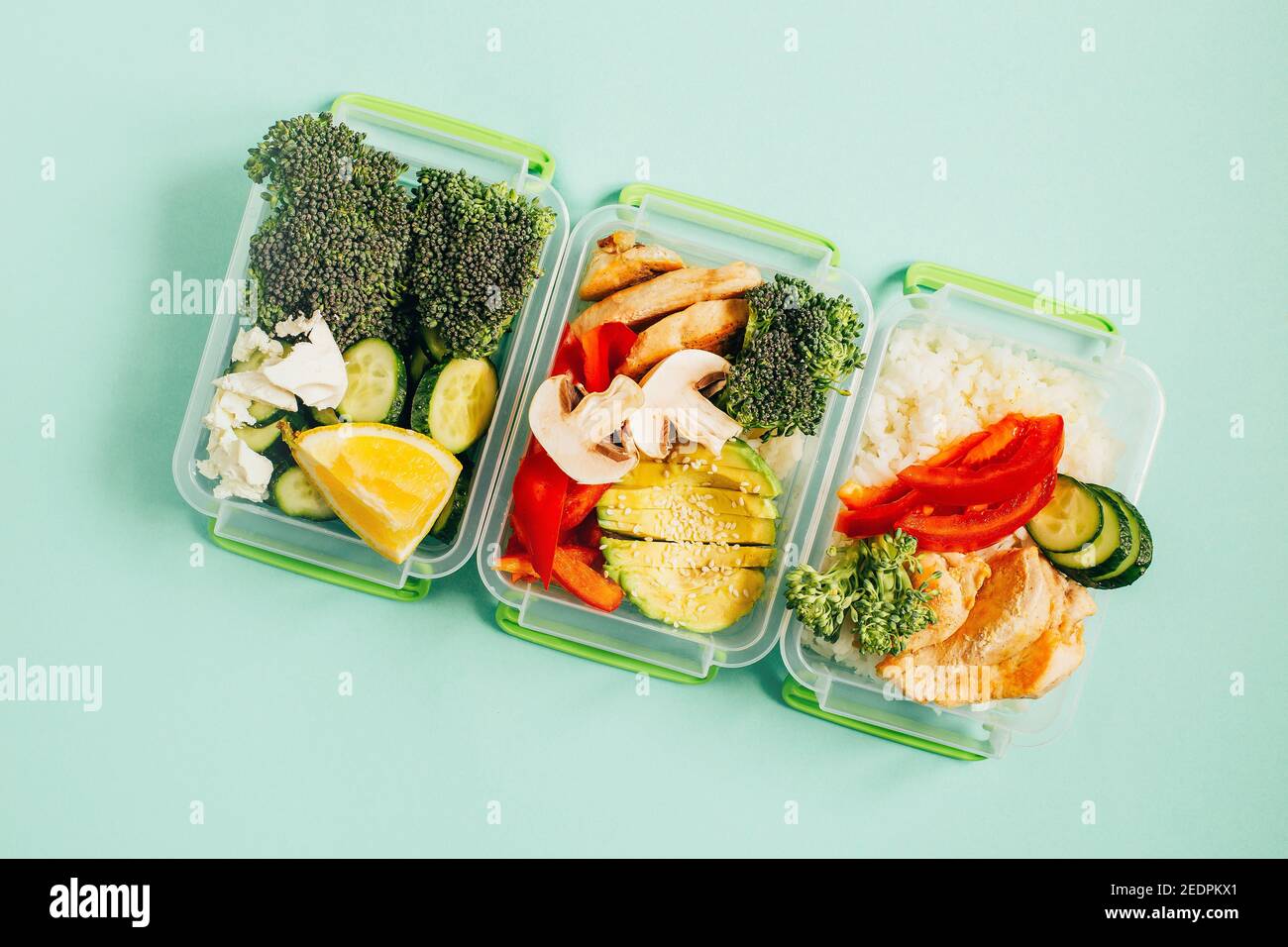 top view of lunch boxes with food on green background Stock Photo - Alamy