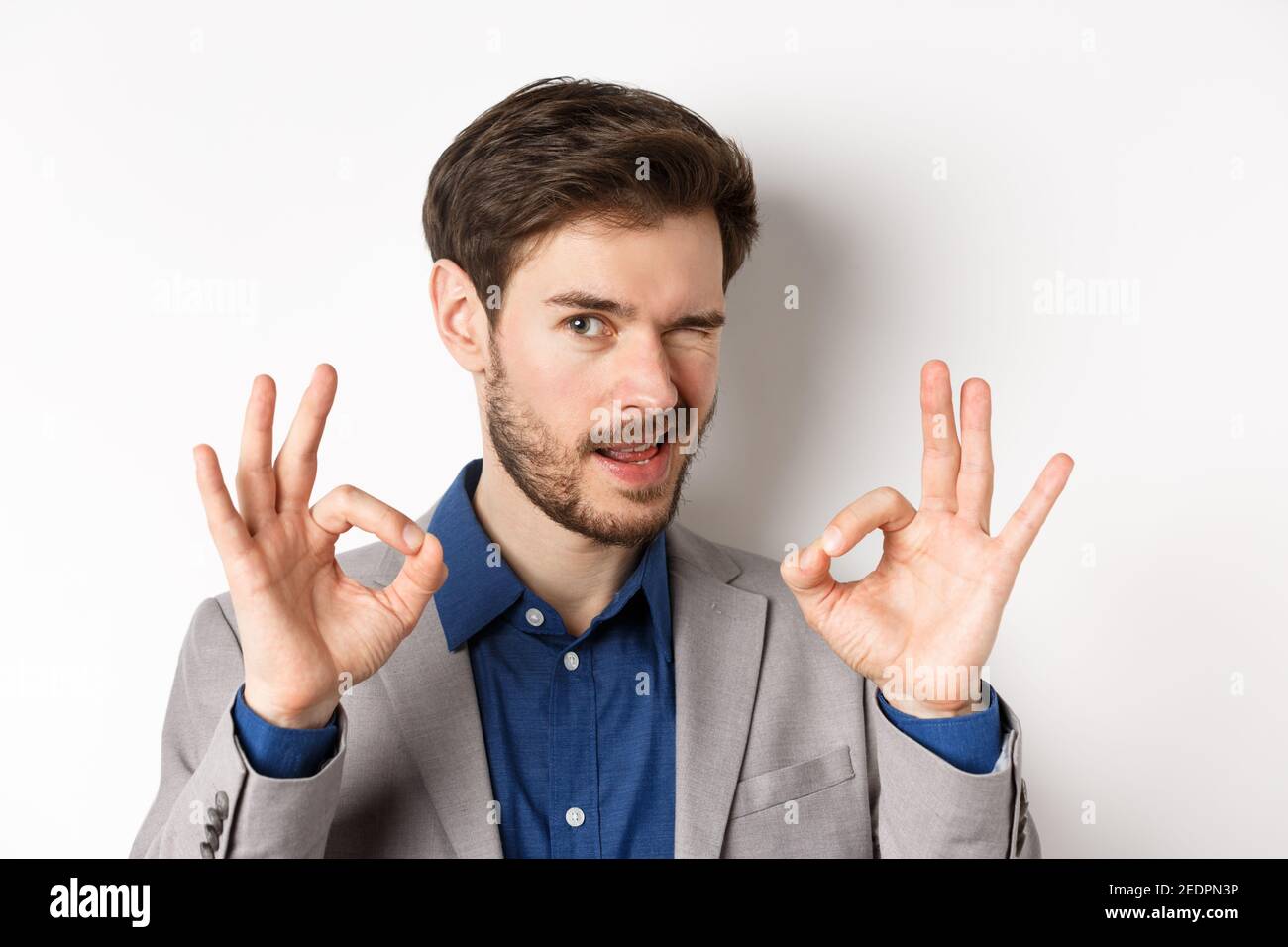 Close up of confident handsome man assuring all good, showing okay ...