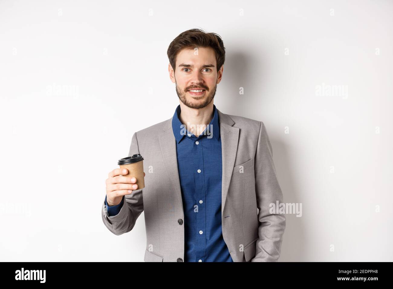 Smiling office worker in suit drinking coffee from paper cup, having ...