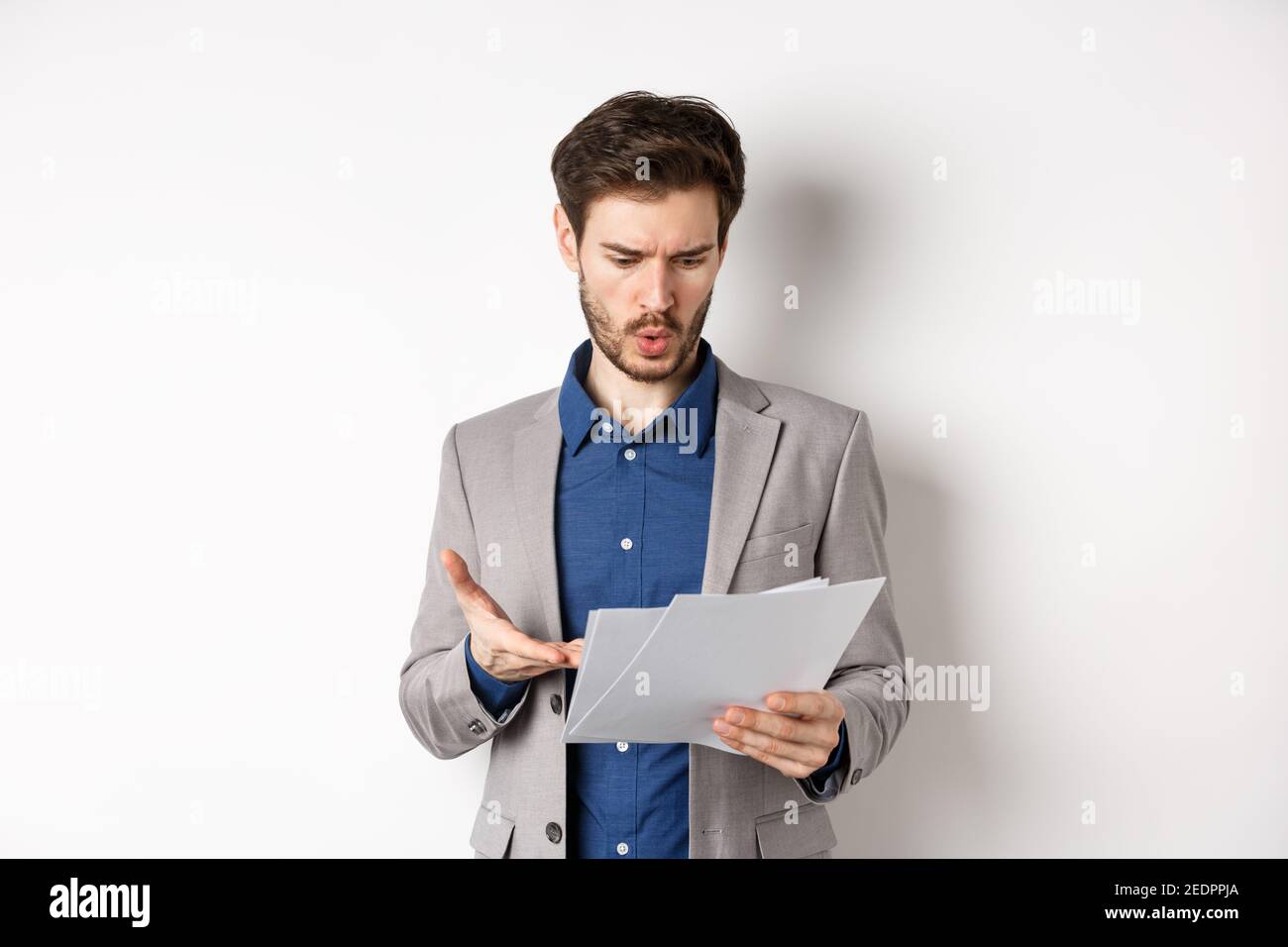 Confused businessman looking at bad document, complaining on deal ...