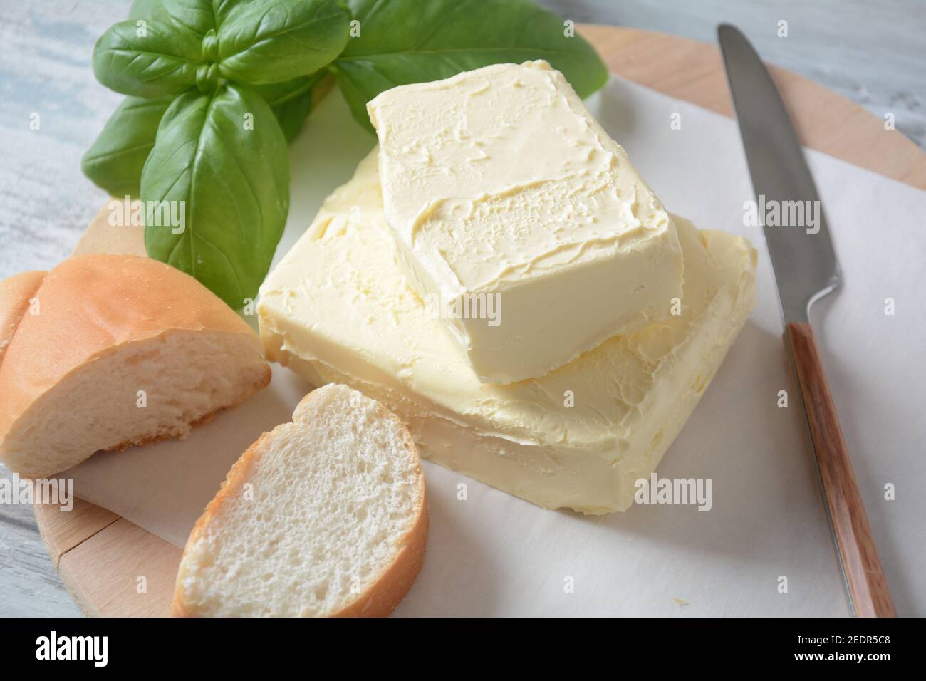 Butter. Slice of butter with basil Stock Photo - Alamy