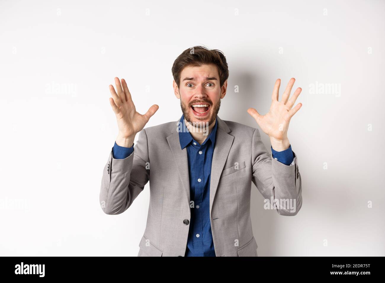 Businessman scream and shake hands in panic, look alarmed and anxious ...