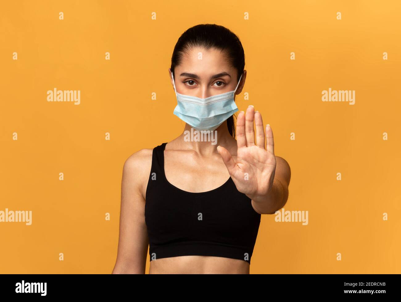 Woman wearing protective face mask showing stop sign gesture Stock ...