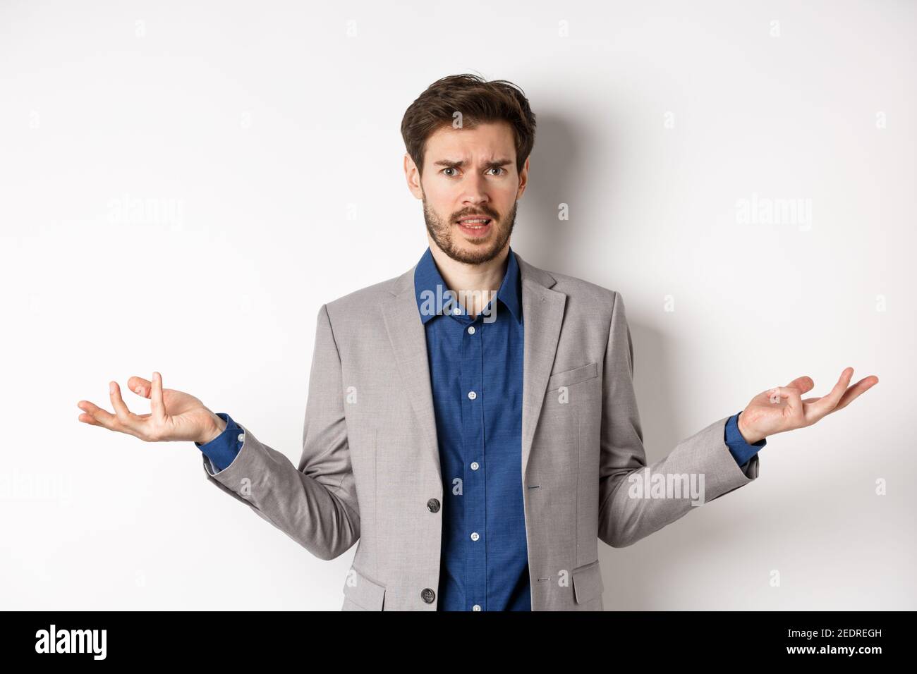 So what big deal. Confused and annoyed businessman spread hands ...