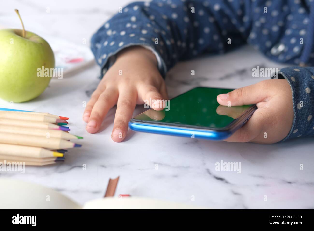 Child girl watching cartoon on smart phone Stock Photo - Alamy