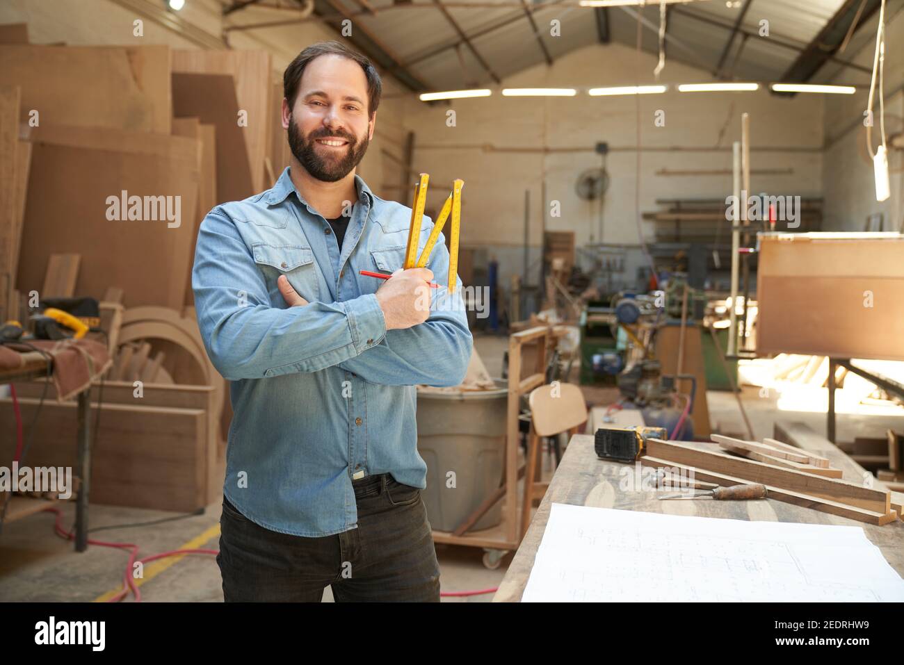 Craftsman and successful start-up founder in his carpentry workshop ...