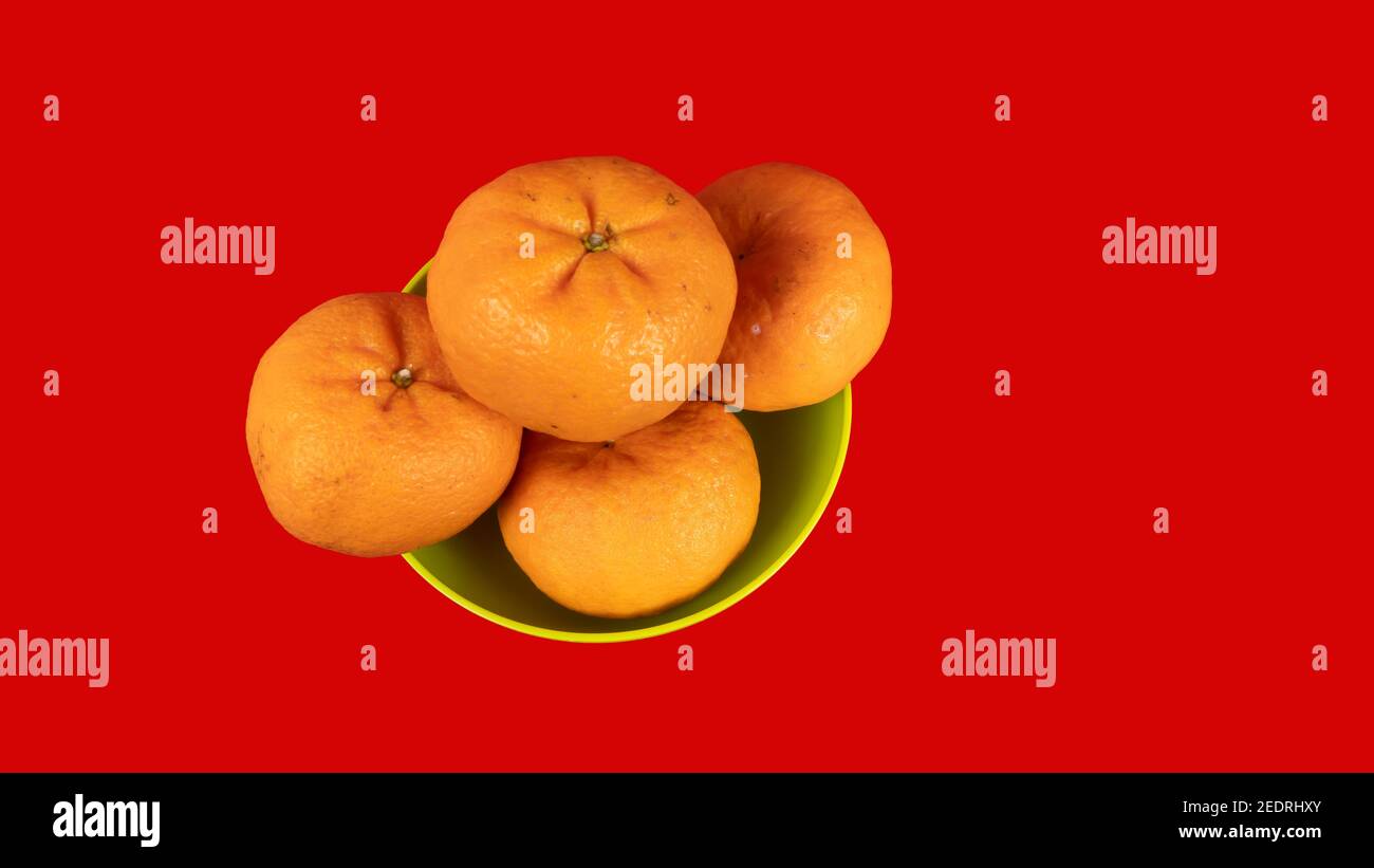 Delicious and beautiful mini Tangerines in the plastic bowl. Selective ...
