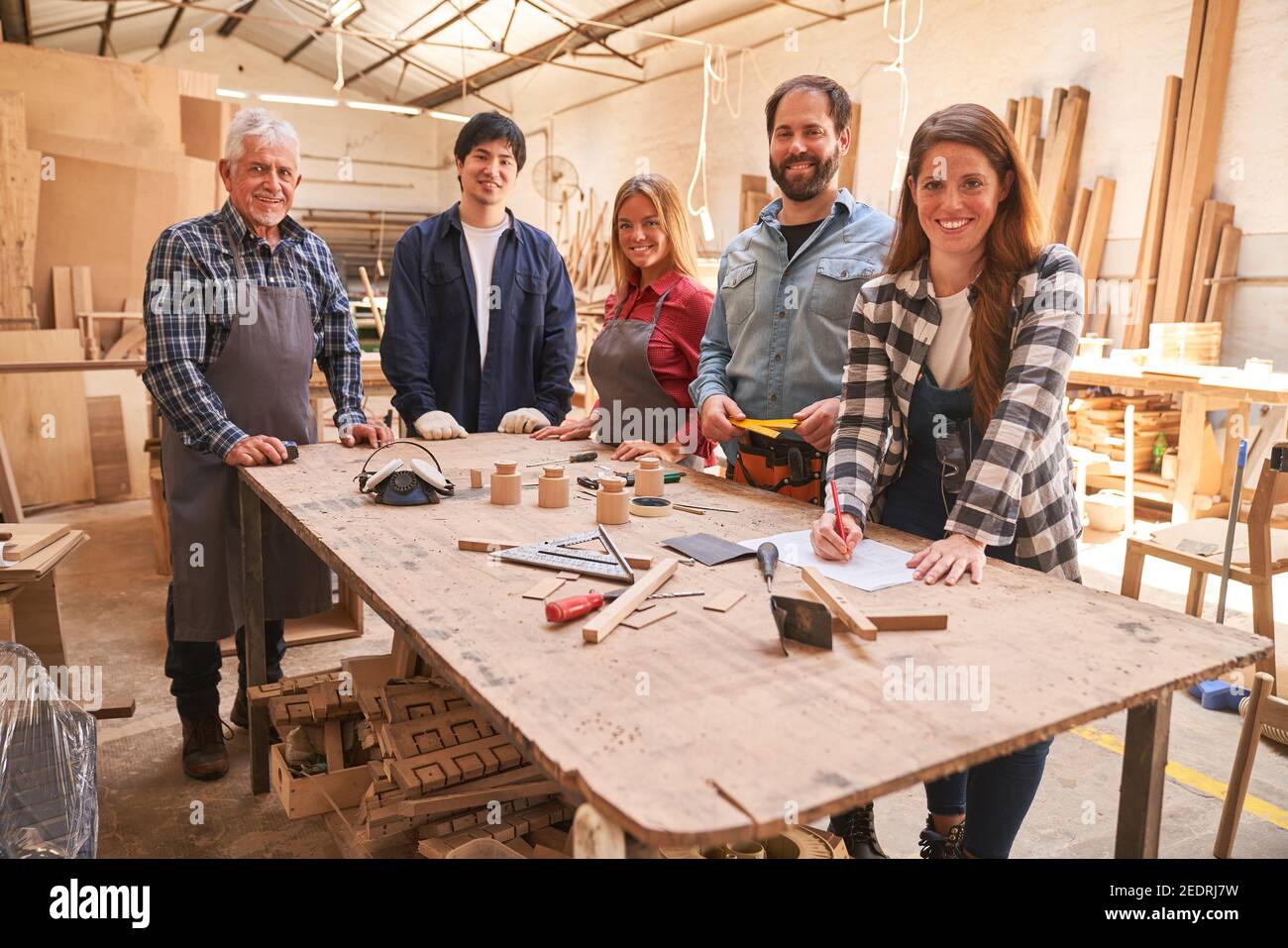 Carpentry team with master craftsmen and trainees in the workshop Stock ...