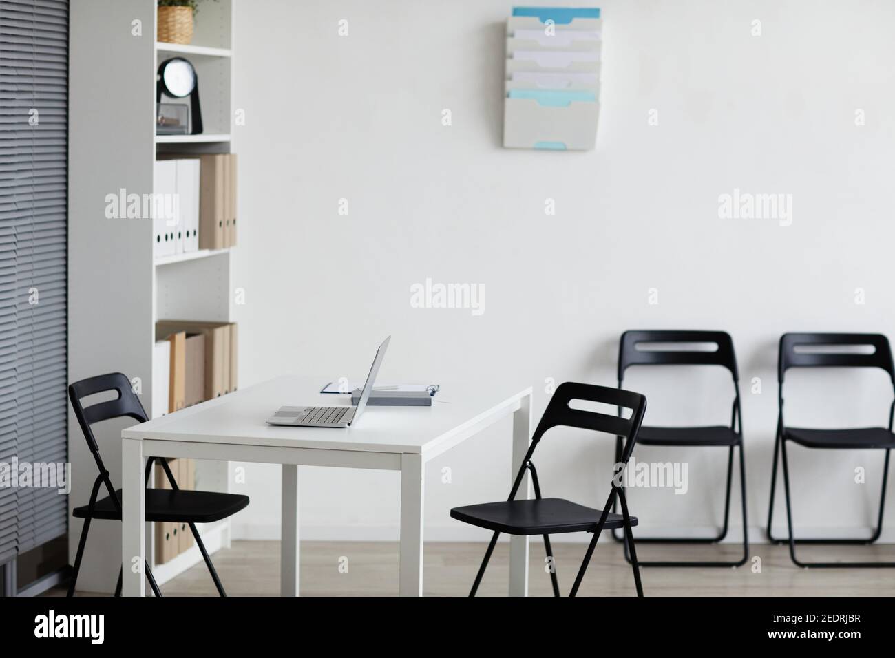 Background image of empty doctors office with desk and chairs in row ...