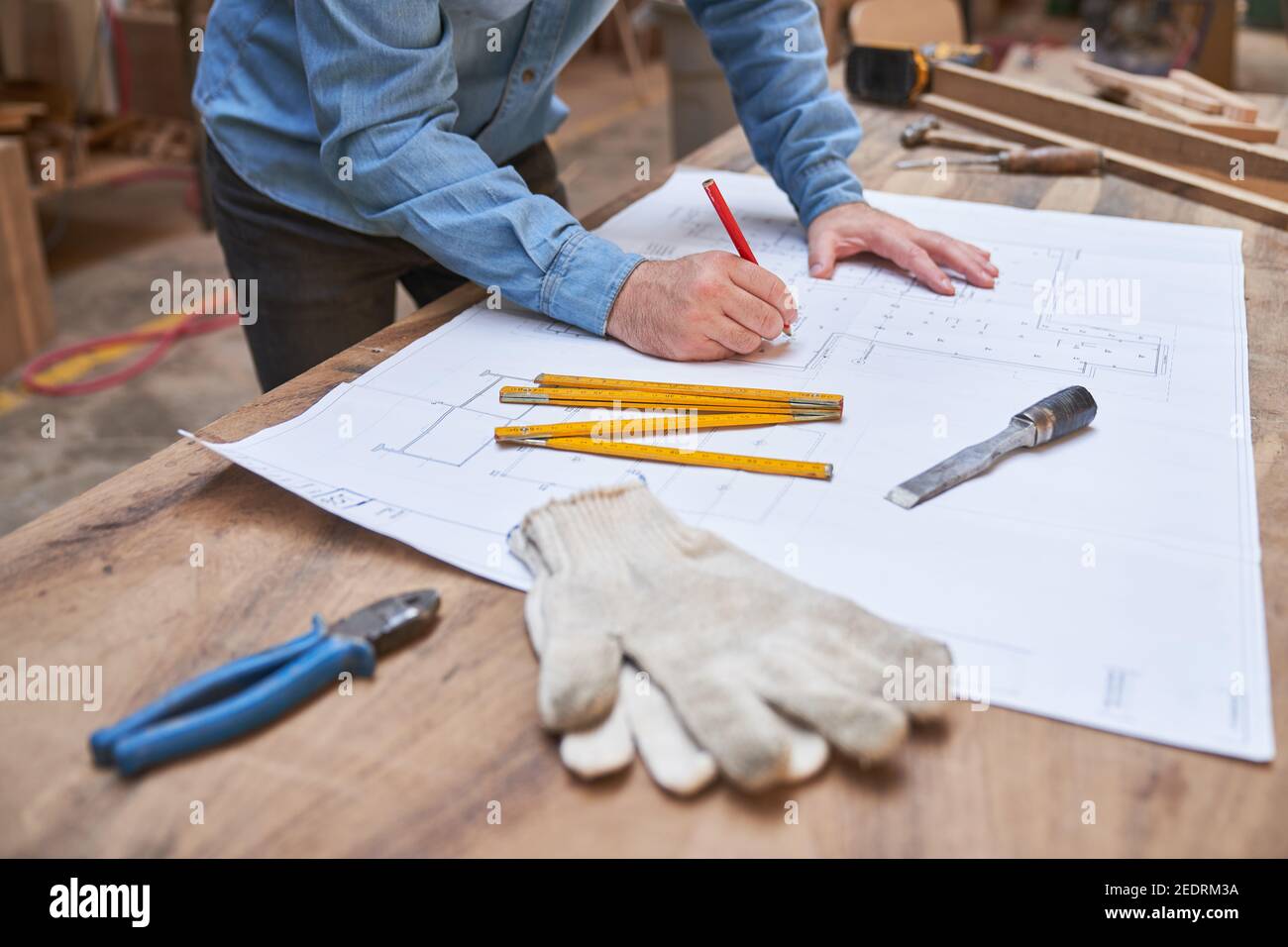 Architect draws a floor plan or blueprint for a house building project ...