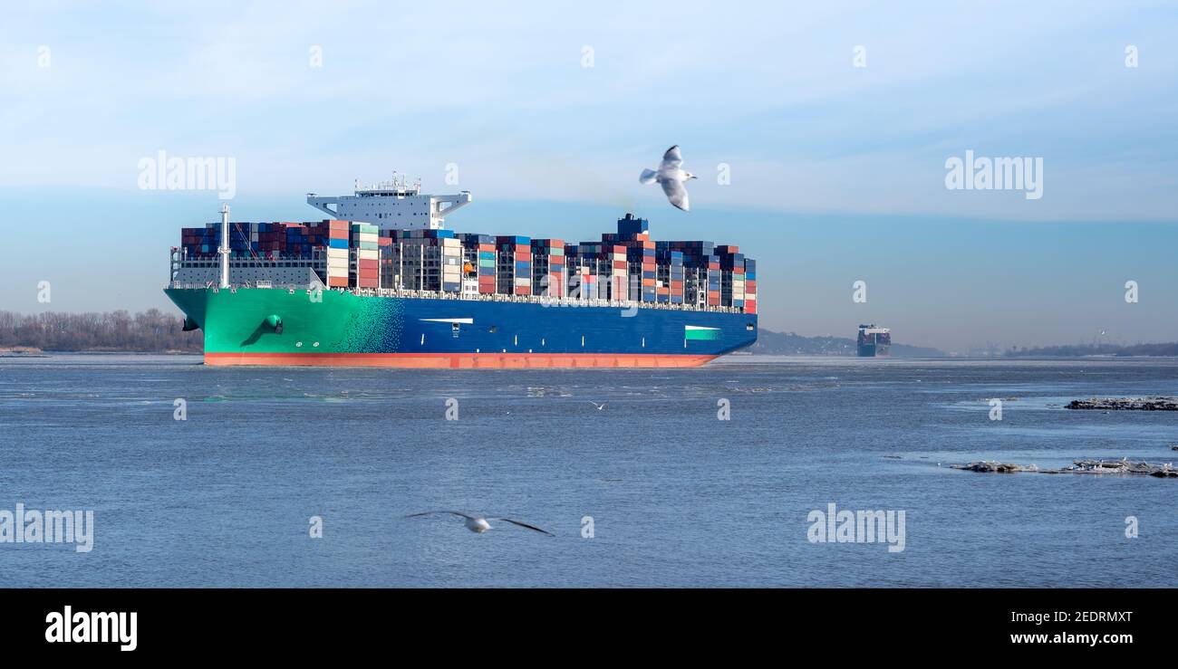 Two large Container ships leaving the port of Hamburg on the river Elbe ...