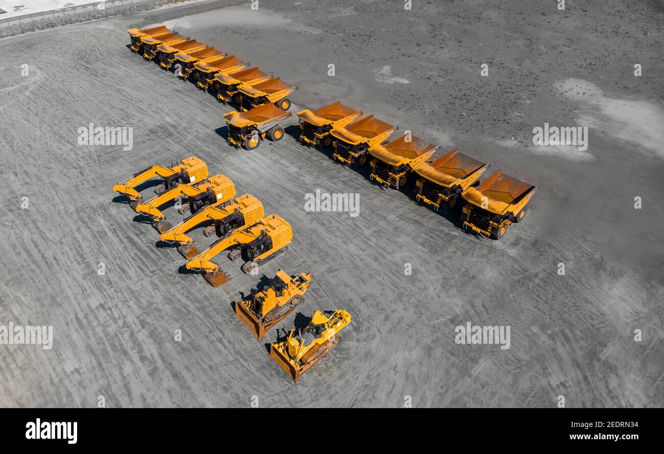 Large parking lot with big yellow mining truck, bulldozers for coal ...
