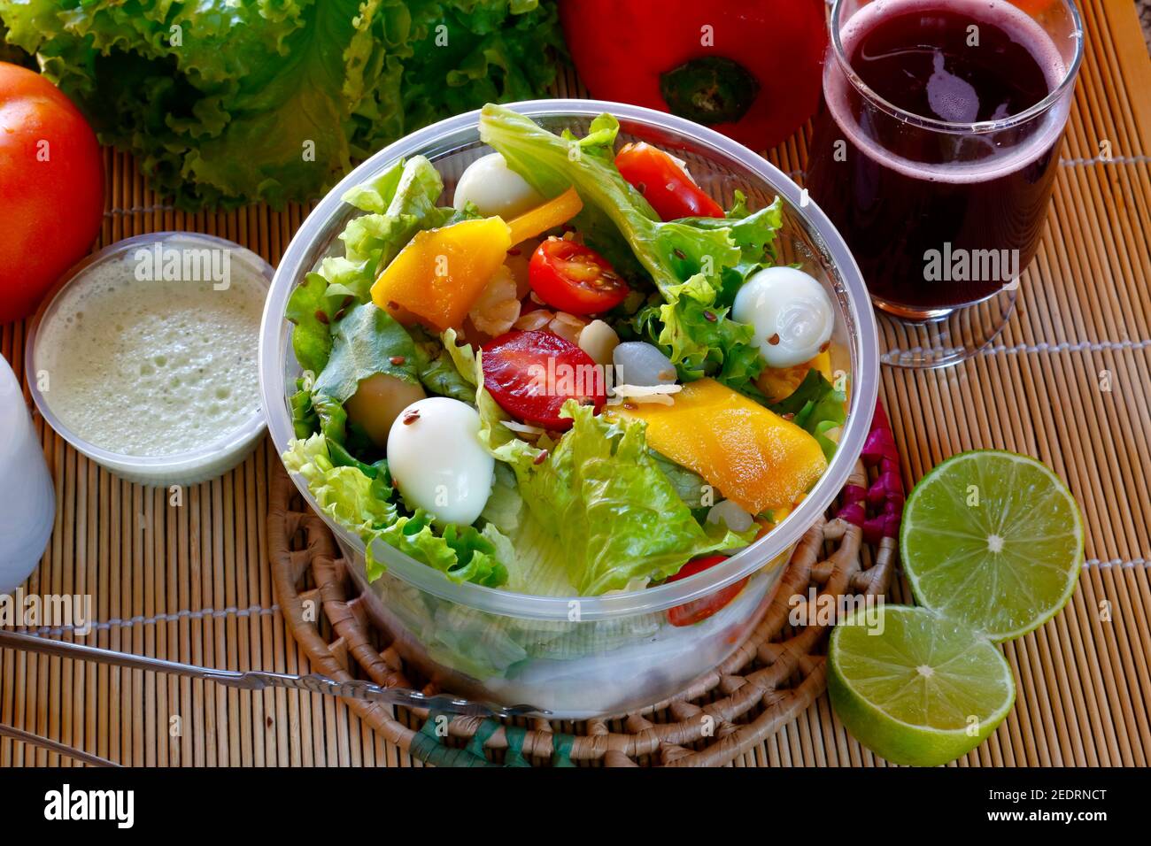 Fresh vegetable salad in an open plastic bowl packing Stock Photo - Alamy