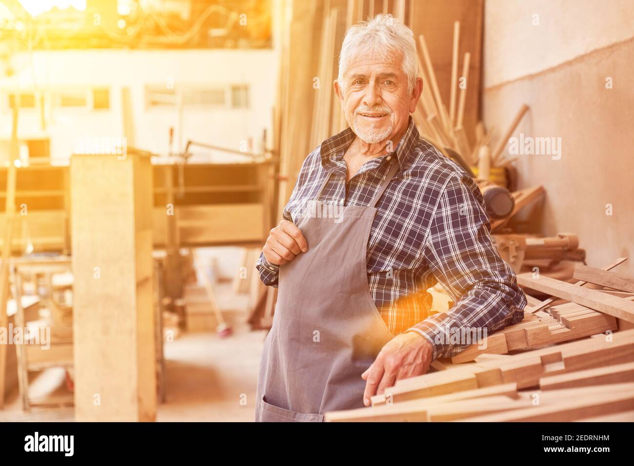 Old man as a happy senior carpenter in his workshop Stock Photo - Alamy
