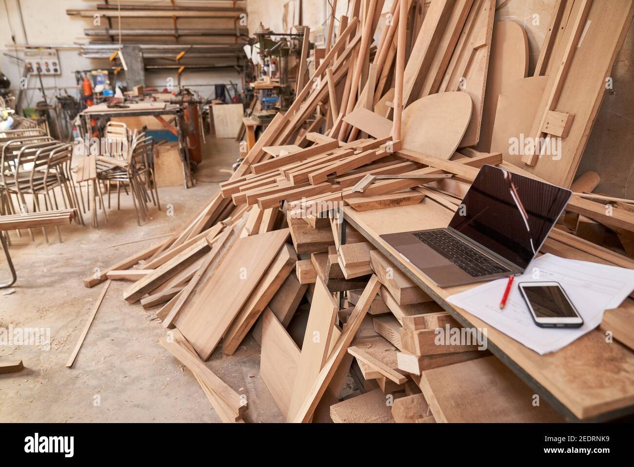 Workplace in carpentry workshop with laptop computer and smartphone ...