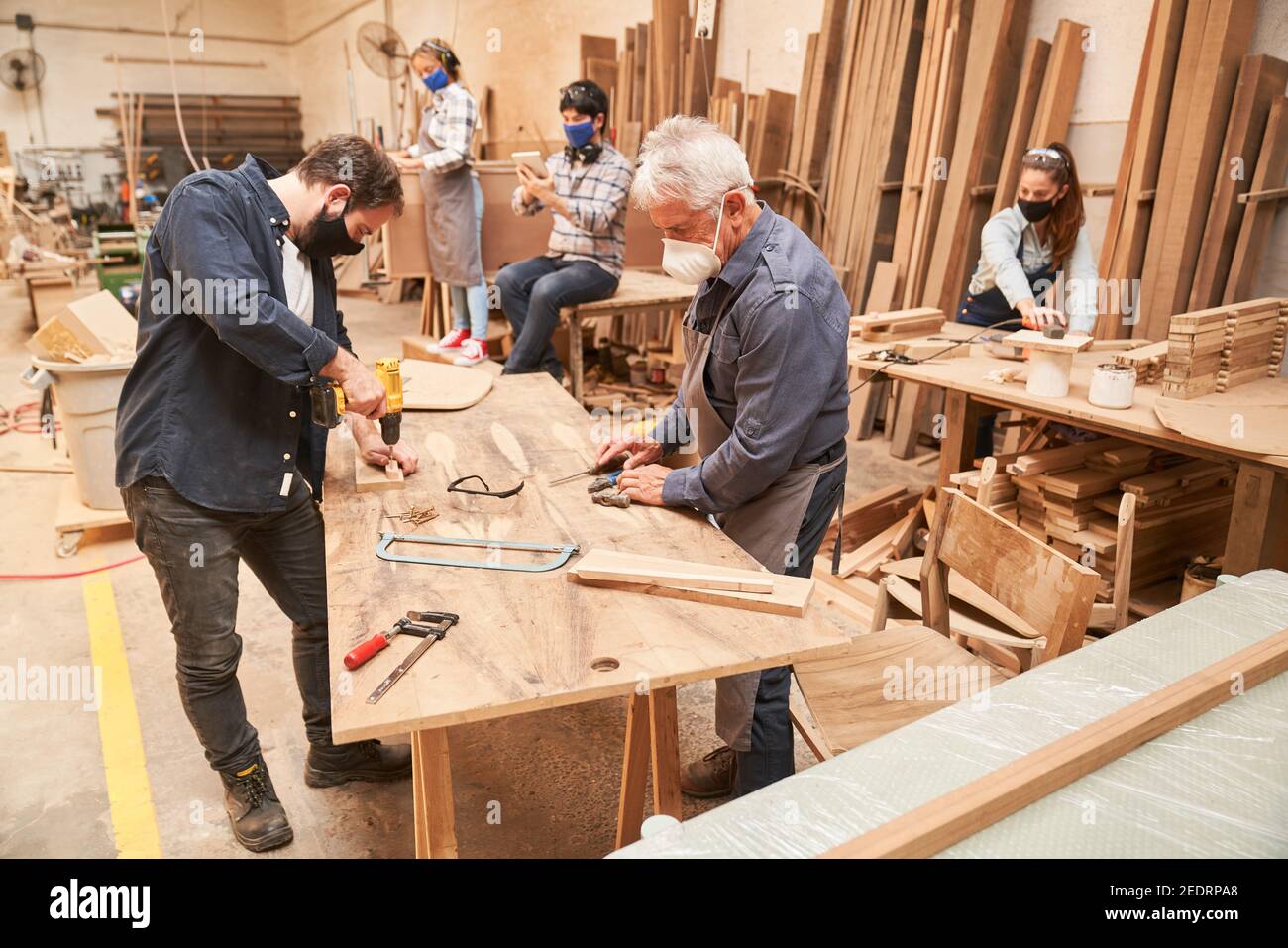 Group of craftsmen with face masks because of Covid-19 at work in the ...