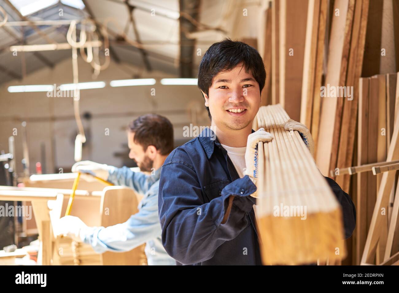 Craftsman apprentice in the wood store of the joinery or joinery ...