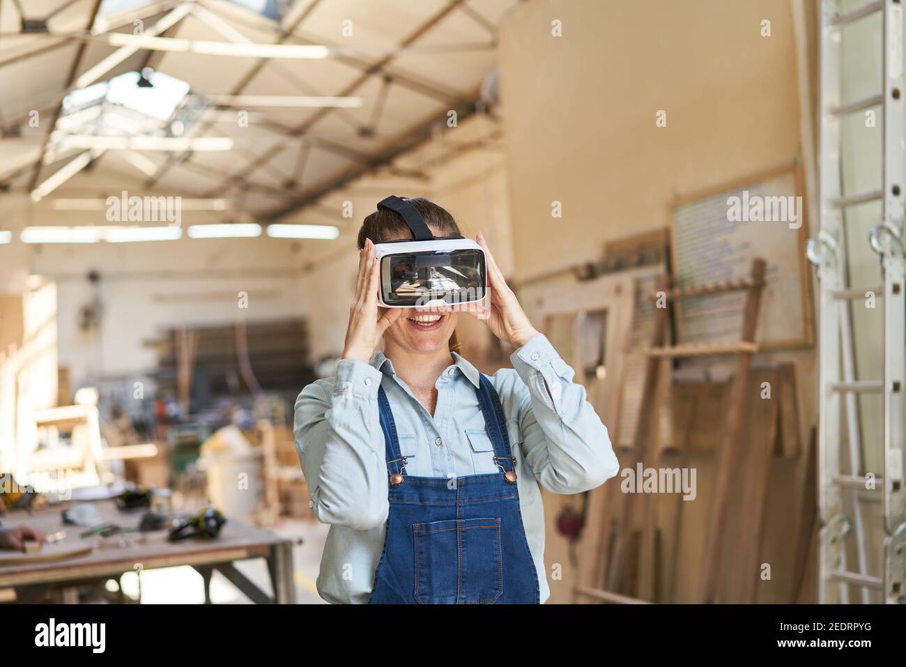 Craftsman woman with VR glasses during virtual reality simulation in ...