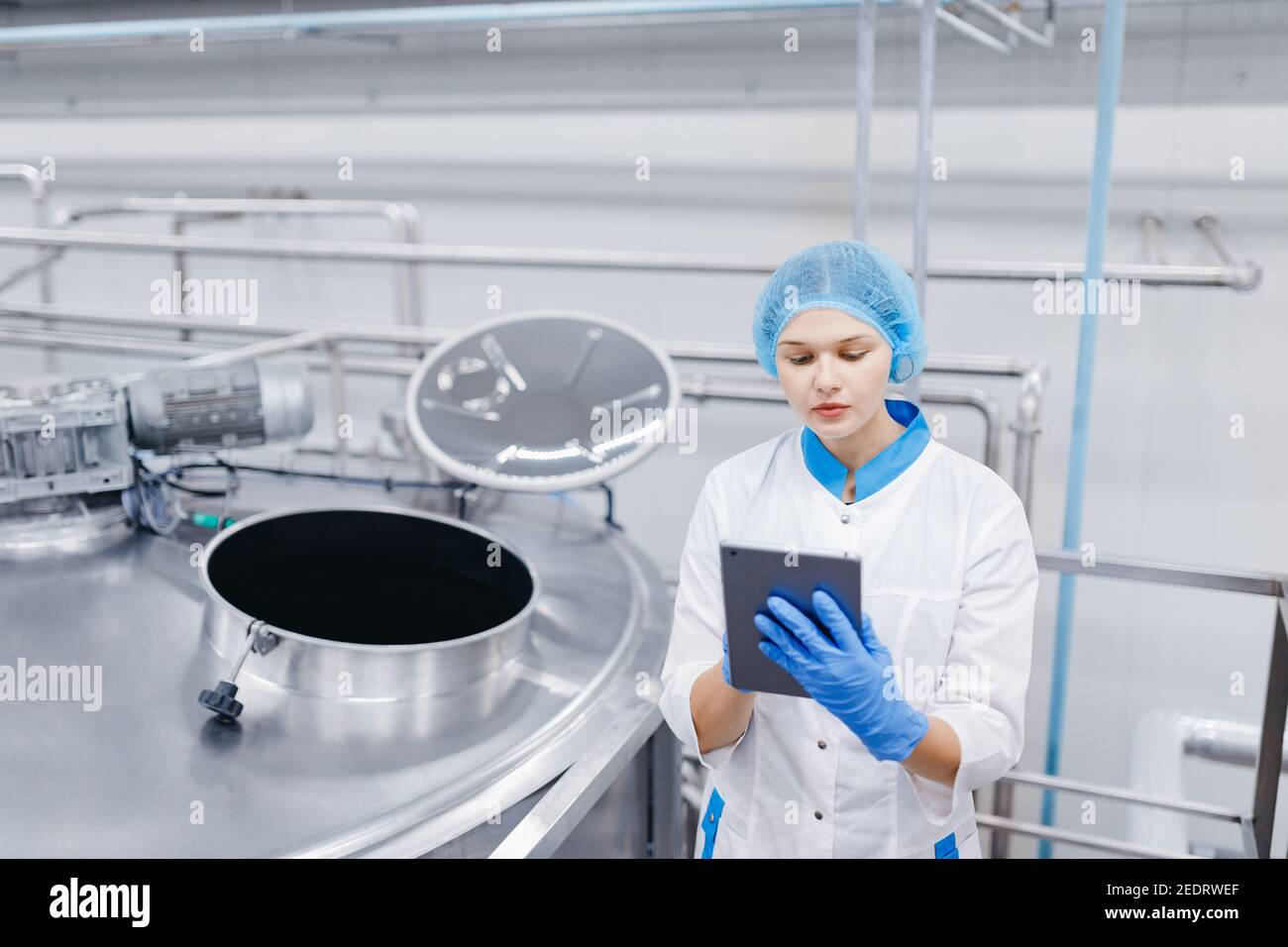 Food automated modern industrial production. Operator worker woman ...