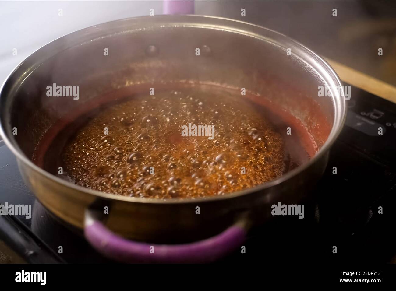 Boiling jam, jam to jam. boiling on fire in a steel plate Stock Photo ...