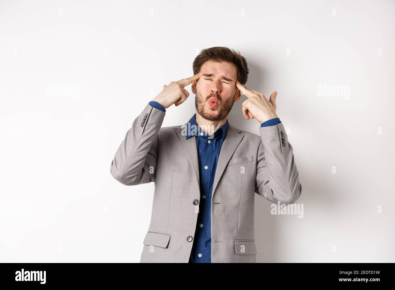 Distressed and tensed businessman pointing at head and complaining ...