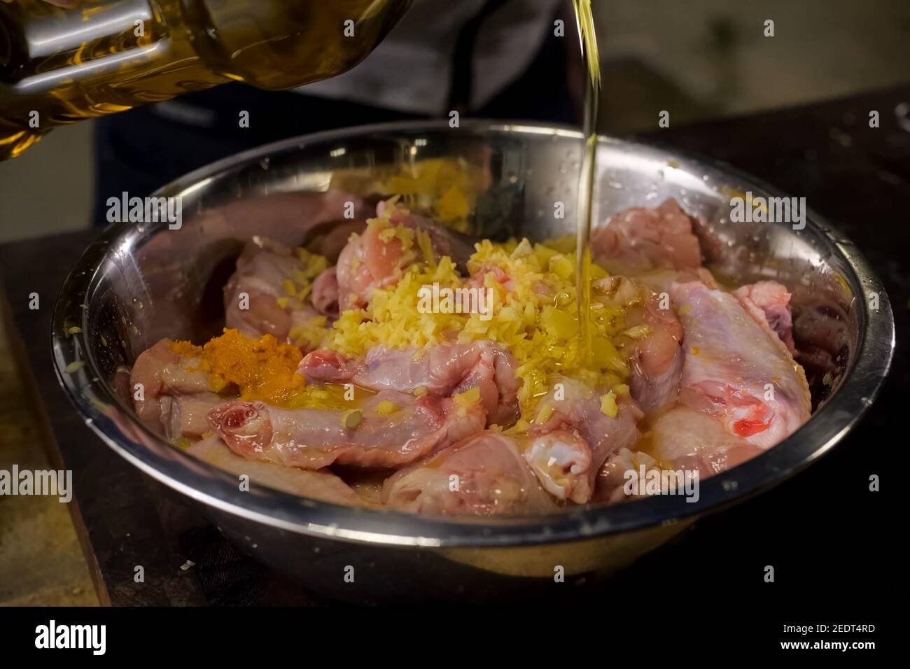 pour chicken meat with sunflower oil. meat frying Stock Photo - Alamy