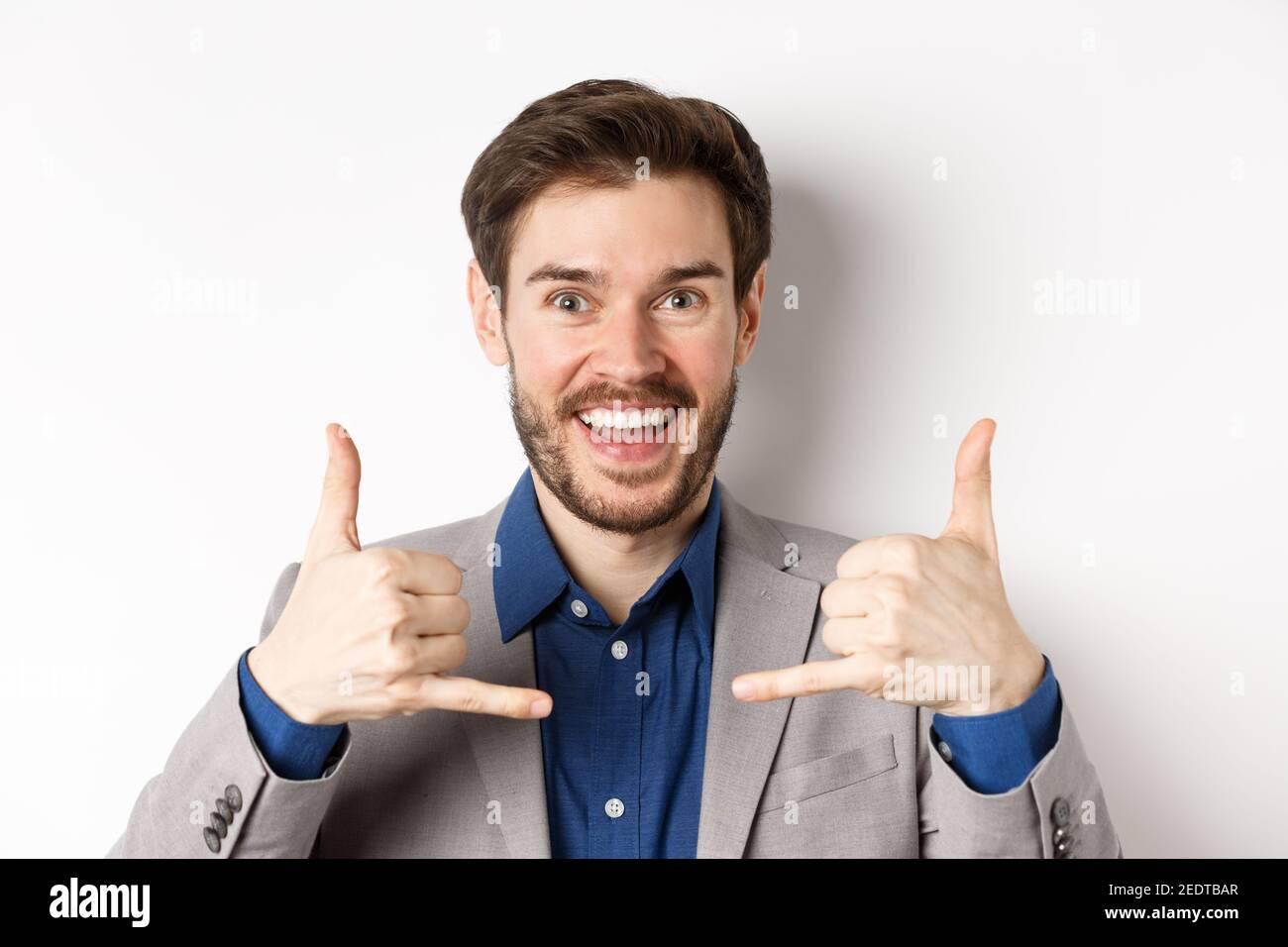 Excited salesman smiling, showing phone signs and asking to give him ...