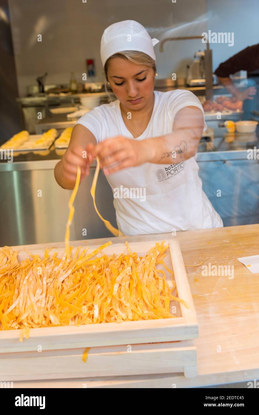 A woman making fresh pasta in a shop window in Bologna Italy Stock ...