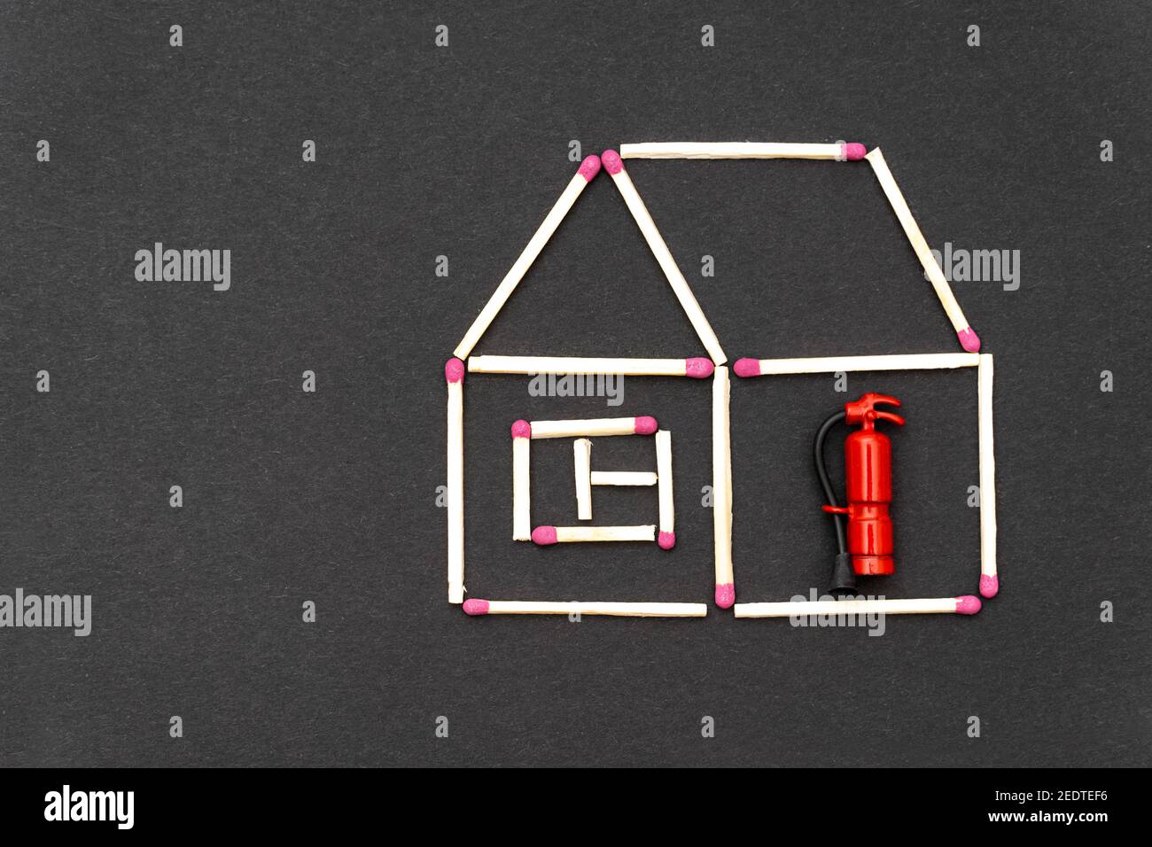 Match house with a miniature fire extinguisher inside.Creative flat lay ...