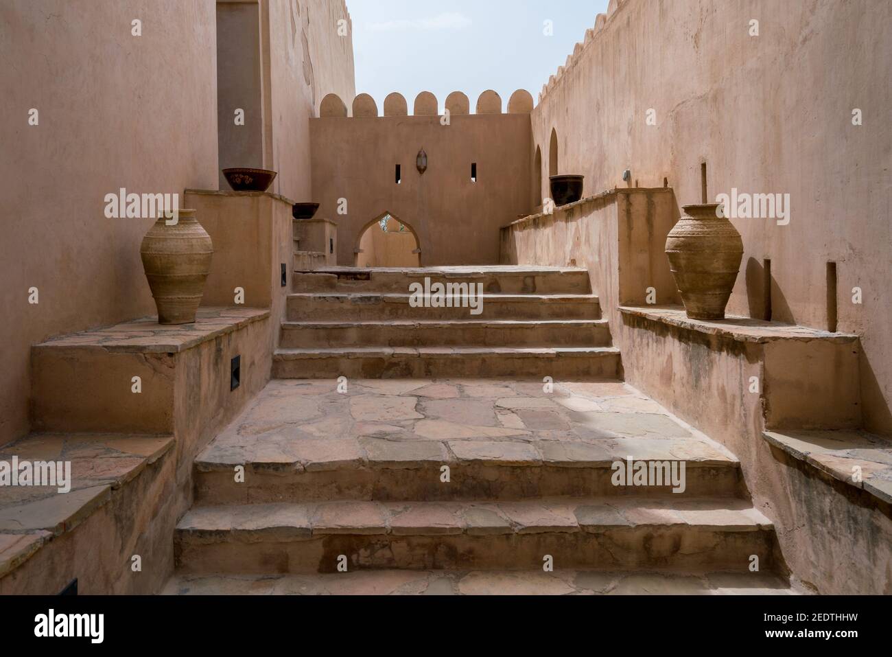 Alley in a medieval arabian fort with stairs, walls and amphoras on ...