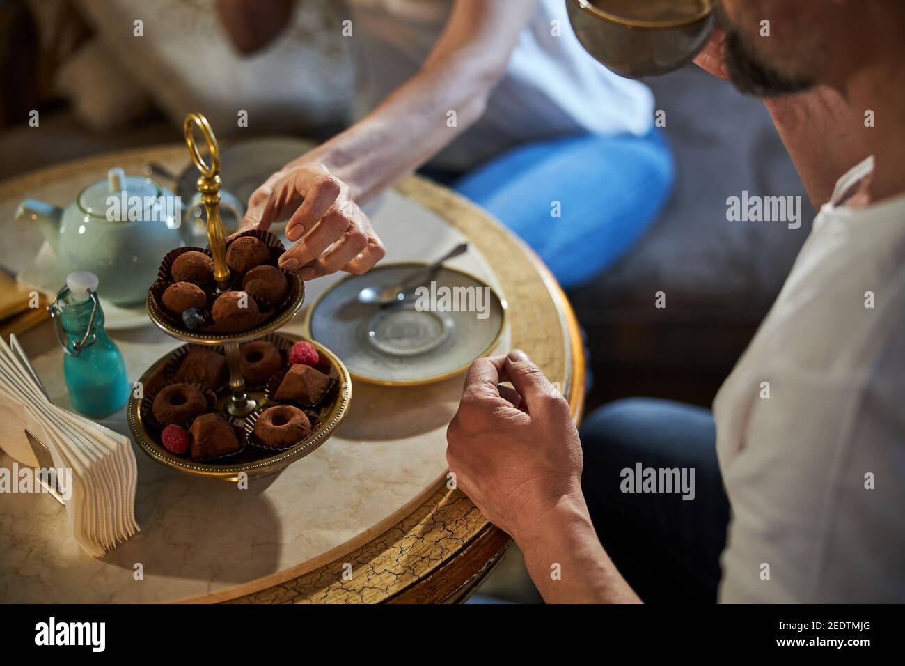 Gentleman and lady enjoying quiet evening with tea and sweets Stock ...