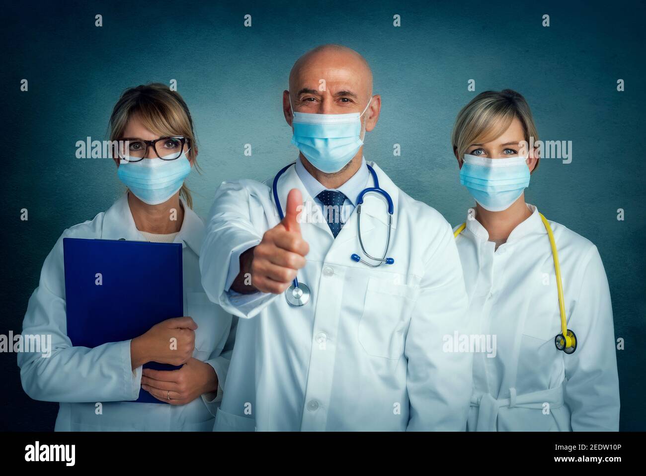Shot of female and male doctors standing together at isolated ...