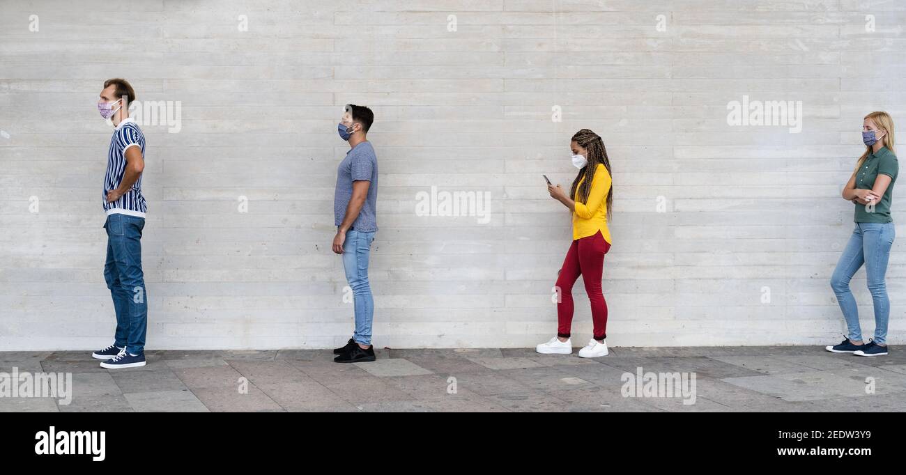 Young people from different cultures and race waiting in queue outside ...