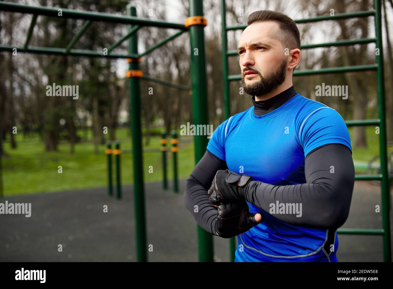 Young strong man stretches his muscles before training Stock Photo - Alamy