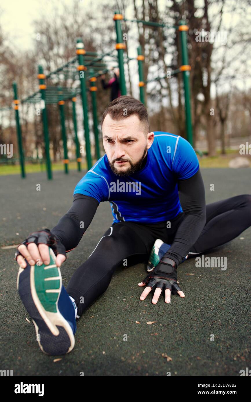 Young strong man stretches his muscles before training Stock Photo - Alamy