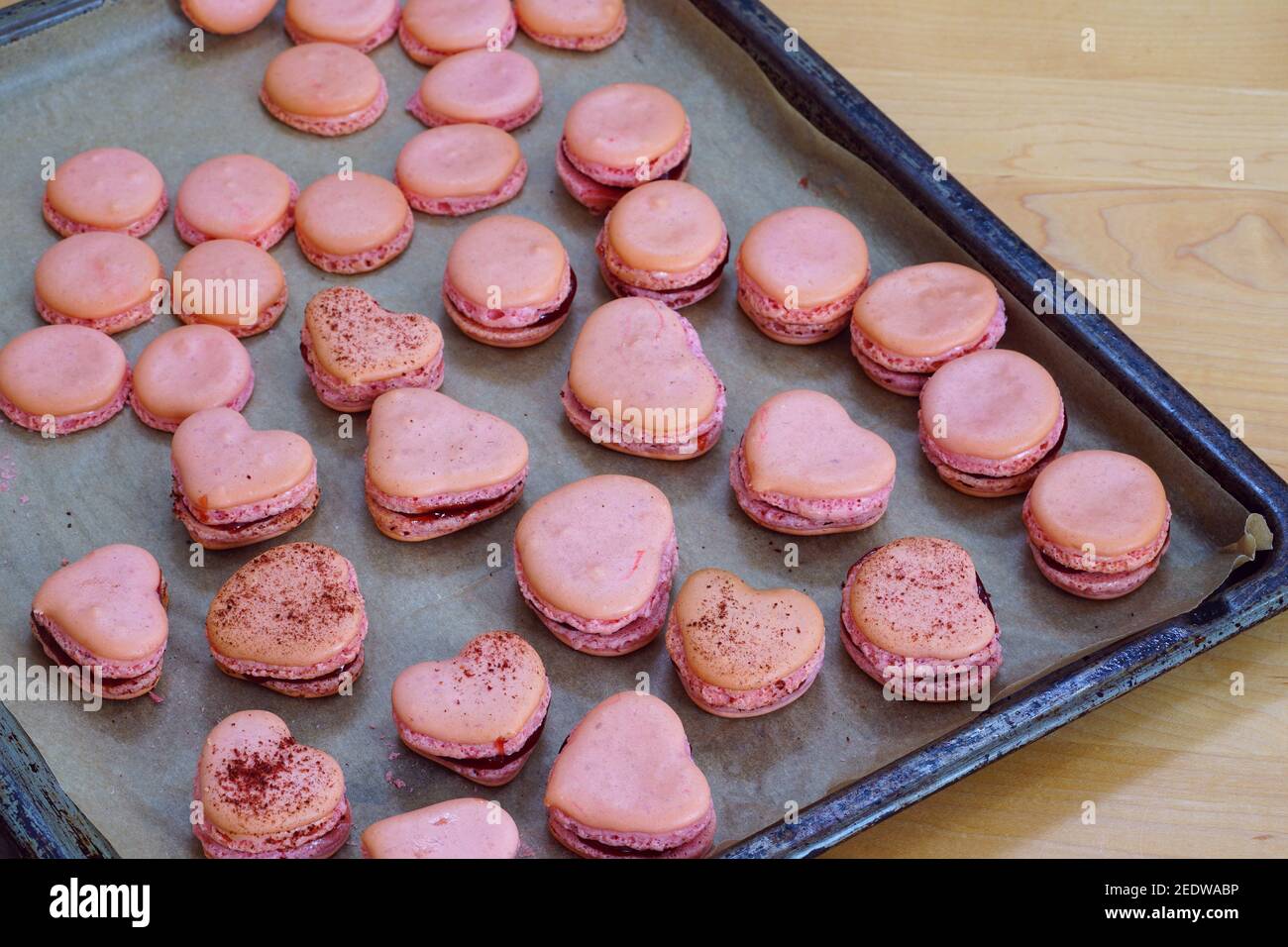 Pink heart homemade macaron cookies filled with raspberry jam on ...