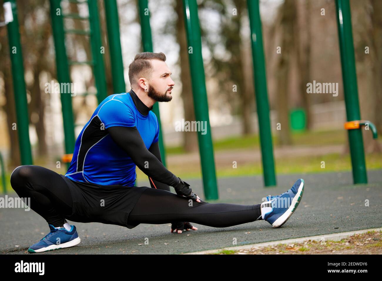 Young strong man stretches his muscles before training Stock Photo - Alamy