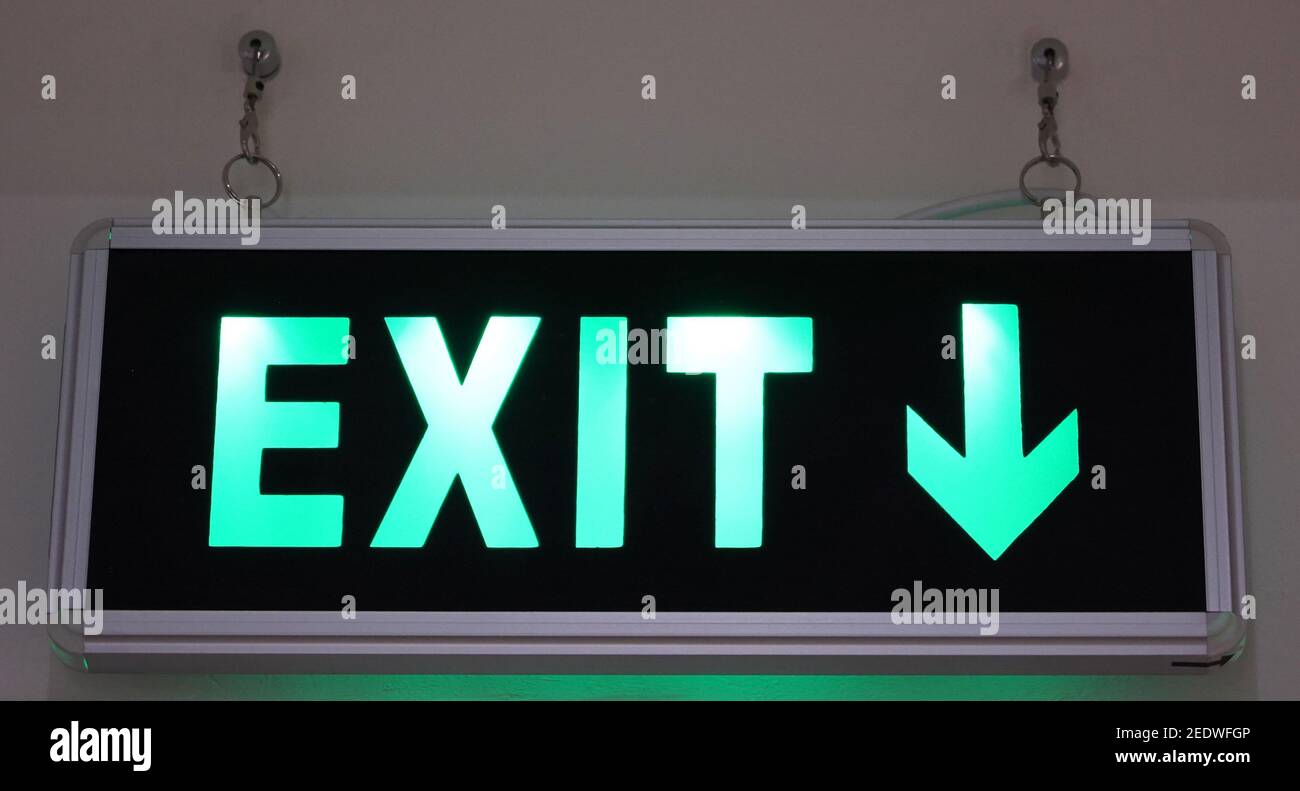 Closeup of a green EXIT sign with an arrow pointing down Stock Photo ...